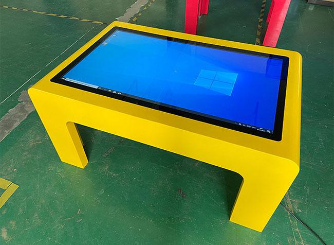 Children using touch table for creative activities