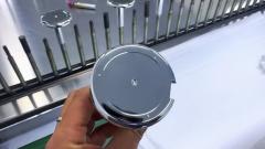 Silver-colored circular plastic part with coating