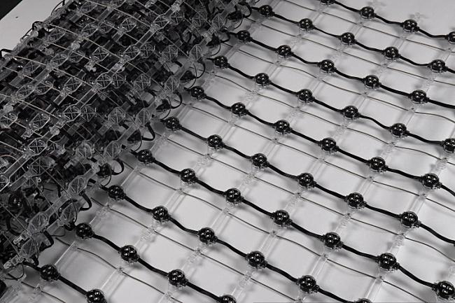 Flexible LED Mesh Display installed on glass curtain building