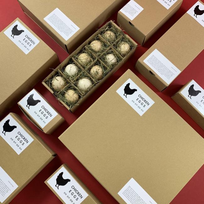 Custom printed brown cardboard egg box showing front view