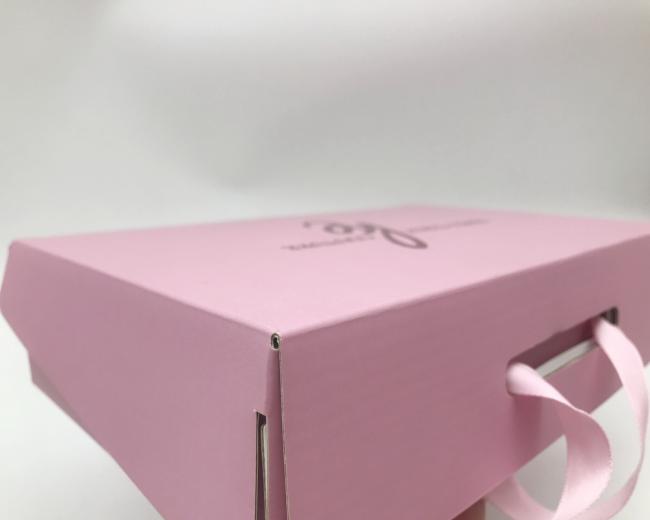 Close-up view of clothing packaging box with custom printing