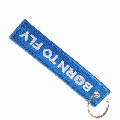 China Persoonlijke sleutelhanger met vliegthema - knappe witte tekst op marine polyester en duurzame metalen ring voor avonturiers Te koop