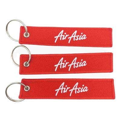 China Double Stitching Custom Embroidered Keychain Metal Loop Design Flight Tag Keyring for sale