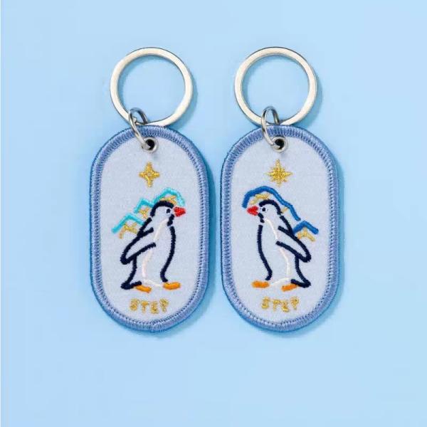Quality Heartwarming Penguin Pair Keychains | Bespoke Keepsakes | Double-Sided Embroidery | Starry Gradient Fabric for sale