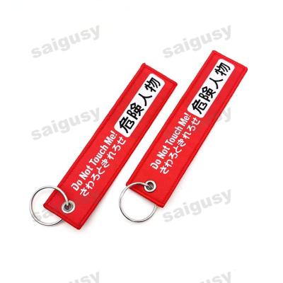 China Dual-Language Warning Car Keychain - Bold 'Dangerous Person' Design - Custom Text & Japanese Style for sale