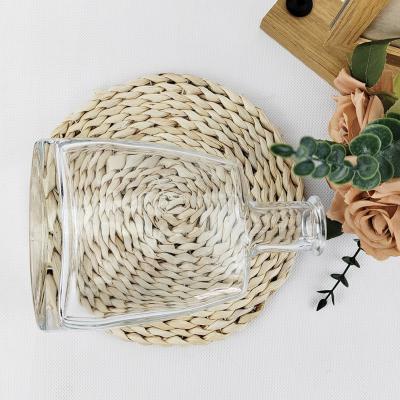 China 500ml Clear Flat Round Empty Whiskey Spirit Tequila Vodka Brandy Glass with Stopper for sale