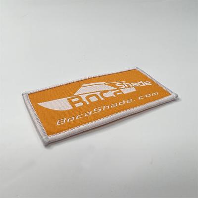 中国 OEMの注文の刺繍されたヴェルクロは編まれたパッチのMerrowのボーダー鉄を修繕する 販売のため