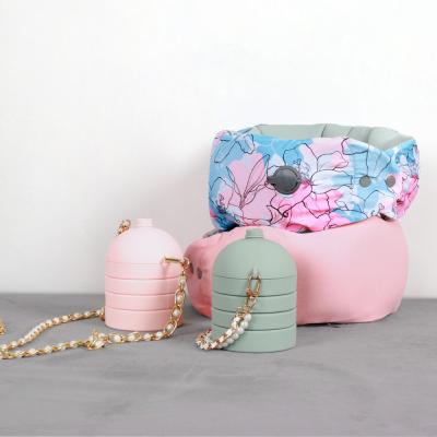 China Almofada para el cuello de viaje de aire hinchable ligera con color personalizado y caja de almacenamiento en venta