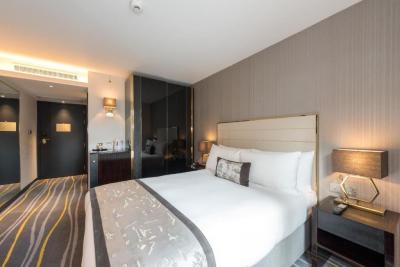 China Melaka light luxury hotel room design of guestroom furniture by Stainless steel leather headboard bed with fashion table for sale