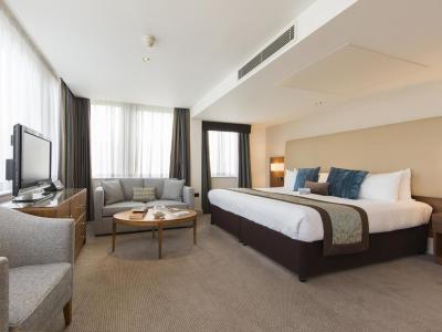 China Pahang guestroom hotel furniture factory for fabric padded bed and tall TV cabinet with sofa chairs for sale
