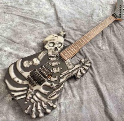 China Skull Carving Body 6 Strings Electric Guitar in Matte Black Color for sale