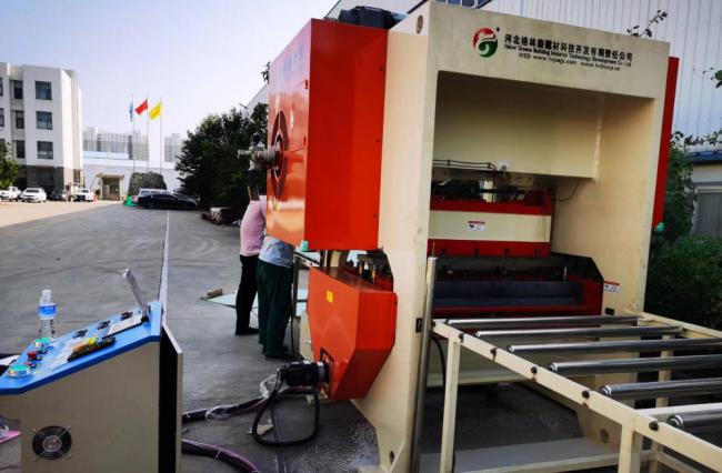 Automatic perforated plasterboard punching machine in operation