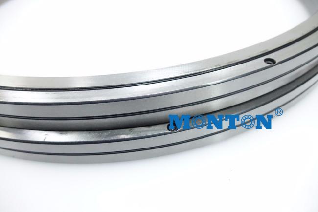 Model RB (Separable Outer Ring Type for Inner Ring Rotation) Being the basic model of the Cross-Roller Ring, its outer ring is separable while the inner ring is integrated with the main body. This model is used in locations where the rotation accuracy of the inner ring is required. Major applications include the index table swiveling unit of machine tools. Structure and Features With the Cross-Roller Ring, cylindrical rollers are arranged with each roller perpendicular to the adjacent roller, in a 90° V groove, separated from each other by a spacer retainer. This design allows just one bearing to receive loads in all directions including radial, axial and moment loads. Since the Cross-Roller Ring achieves high rigidity despite the minimum possible dimensions of the inner and outer rings, it is optimal for applications such as joints and swiveling units of industrial robots, swiveling tables of machining centers, rotary units of manipulators, precision rotary tables, medical equipment, measuring instruments and IC manufacturing machines. Concept of the Cross Roller Ring The Cross-Roller Ring is a high-rigidity, compact, and easy-to-use product designed based on the double cone roller bearing and angular contact ball bearing which had been popular. Applications: •Industrial Robotic arm,Reducer drive •precision Turntable,NC rotary table •Rotation part of Machine tools •Inspection instrument,Medical equipment • Aviation equipment,Military radar etc