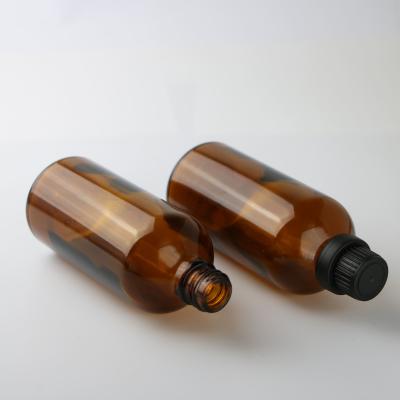 China Clear Amber Glass Essential Oil Bottles 50ml 100ml 200ml With Black Cap for sale