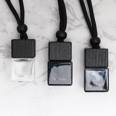 China 8ml Black Aroma Diffuser Bottle Diffuser Glass Hanging Perfume Bottle With Black Wood Lids for sale
