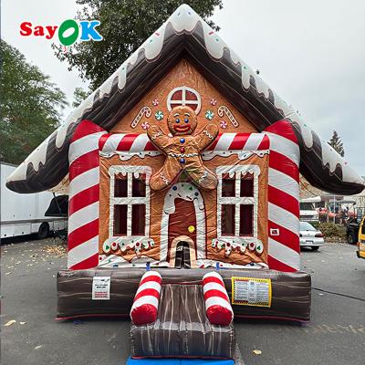 China Free 3d Design 0.55mm PVC Tarpaulin Christmas Inflatable Bouncing Castle Gingerbread Bounce House With Blower for sale