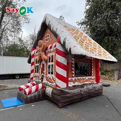 China Free 3d Design 0.55mm PVC Tarpaulin Christmas Inflatable Bouncing Castle Gingerbread Bounce House With Blower for sale