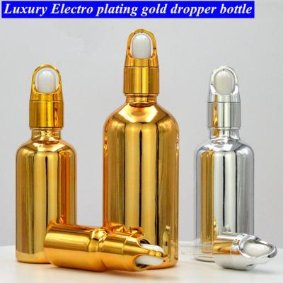 Cina 10ml 20ml 30ml 50ml Elettroplate Colore Oro Imballaggio Cosmetico di lusso Bottiglie gocciolanti in vetro per uso di oli essenziali in vendita