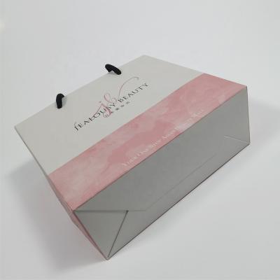Cina Carta di stampa offset Borse per imballaggio regalo Abbigliamento cosmetico di lusso Borse regalo in vendita