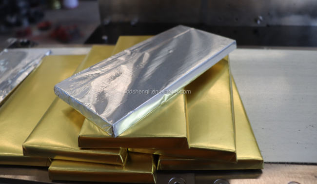 Close-up of chocolate tablet wrapping mechanism