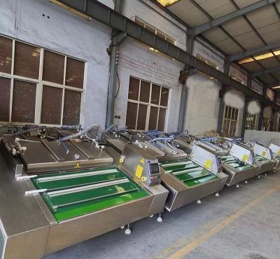 China Automatic Continous Rolling Belt Type Vacuum Packaging Machine for Fruit Meat Fish Chicken for sale