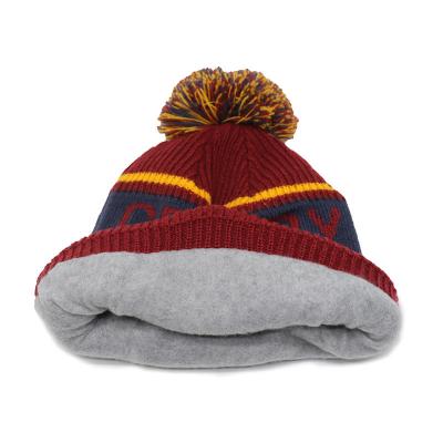 China Custom Embroidery Logo Kids Knitted Winter Warm Beanies With Pom Pom Fleece Lined for sale