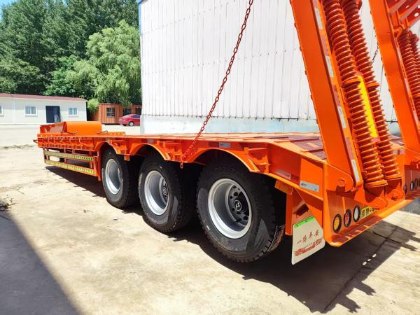Quality Orange 3-Axle Lowboy Semi-Trailer: 60T Payload, Sturdy Design for Heavy Loads for sale