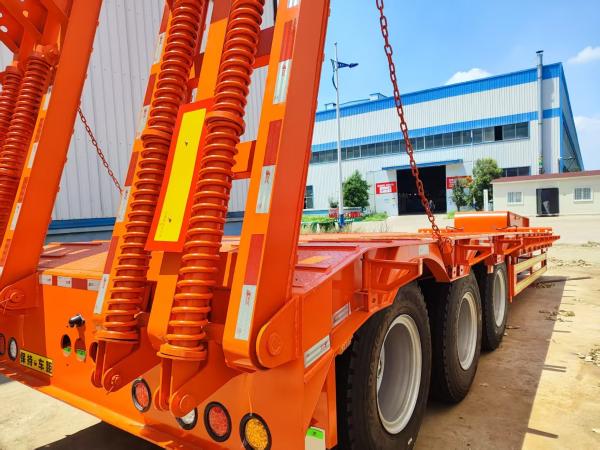 Quality Orange 3-Axle Lowboy Semi-Trailer: 60T Payload, Sturdy Design for Heavy Loads for sale