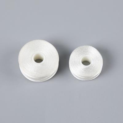 Cina 2 cm di diametro ricamo filo di fondo bianco senza confine L-tipo 75D/2 Shuttle Core cucitura prefondato bobbin 6 in vendita