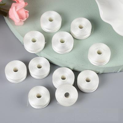 Cina 2 cm di diametro ricamo filo di fondo bianco senza confine L-tipo 75D/2 Shuttle Core cucitura prefondato bobbin 6 in vendita