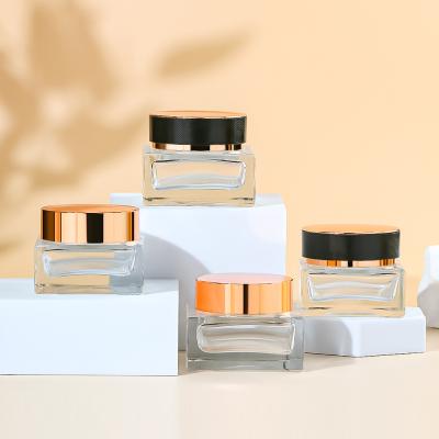 China Luxury Thick Wall Glass Cream Jar with Leak-proof Gold Lid and Customizable Capacity for High-End Skincare for sale