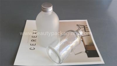 China Boston Shape Transparent Beverage Glass Bottle With Aluminum Lid for sale