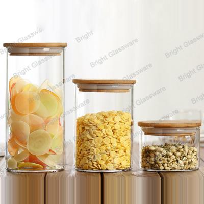 China High quality round cylinder glass candy jar crystal glass jar with wood lid for sale