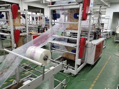 Cina Good price biodegradable plastic tshirt and flat bag cutter machine with conveyor belt in vendita