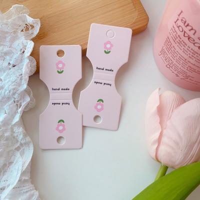 China Pink Floral Hair Tie Display Cards 100pcs 9x3.5cm for sale
