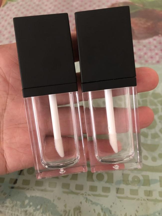Close-up of lip gloss tube wand and container