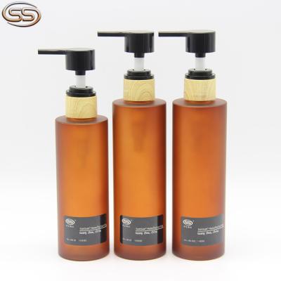 China 200ml 250ml Amber Frosted Plastic Shampoo Bottle with Bamboo Lotion Pump for sale
