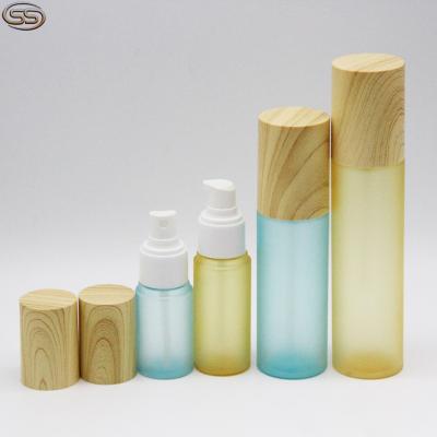 China Custom Color Frosted Plastic Cosmetic Lotion Pump Bottle with Bamboo Cap for sale