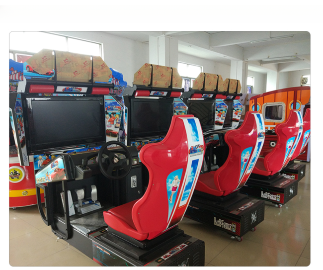 Close-up view of racing game controls including steering wheel and pedals