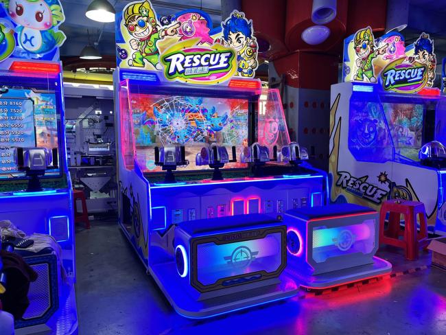 Side view of game machine showing coin mechanism and cabinet details