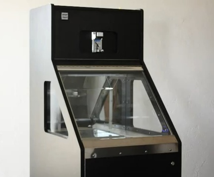 Close-up of coin pusher tray and controls