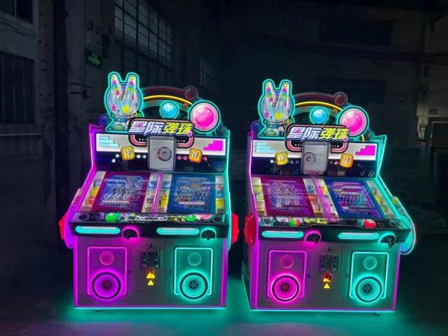 Children playing the marble game machine