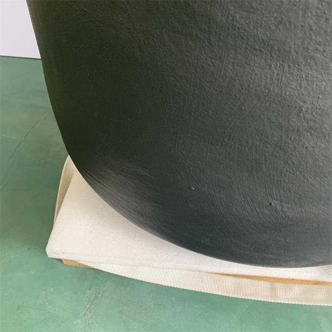 Close-up of graphite crucible showing material texture and construction