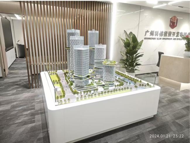 Architectural model showing multi-tower complex with lighting