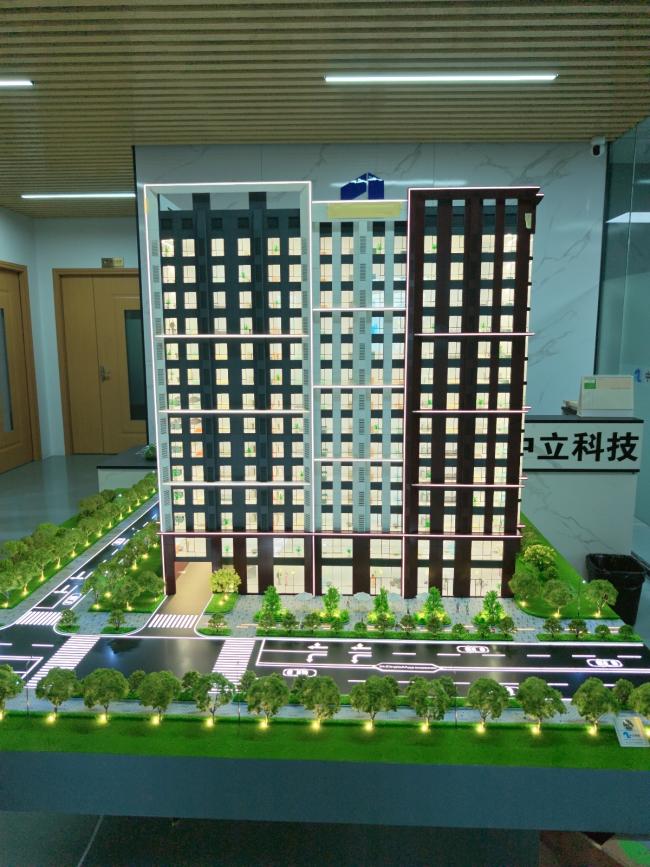 Detailed architectural scale model showing high-rise building with surrounding environment