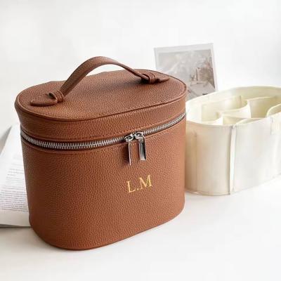 China Custom Logo Leather Travel Makeup Case Toiletry Bag With Removable Compartment for sale