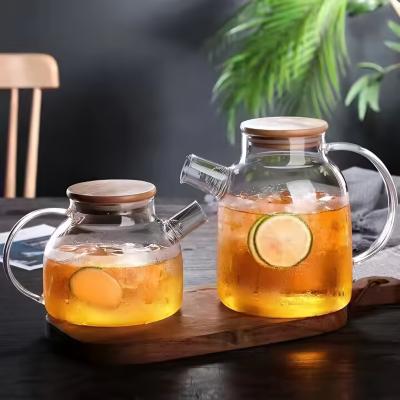 China 1L 1.8L High Borosilicate Glass Kettle With Handle Mental Lid Filter Large Capacity for sale