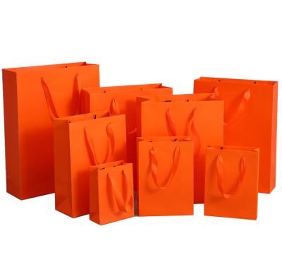 China Wholesale Embossed Gold Boutique Packaging Custom Shopping Pink Kraft Paper Bag With Logo for sale