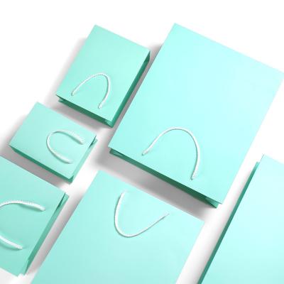 China Custom Logo Printed Christmas Gift Bag Small Paper Shopping Clothing Packaging Bag for sale