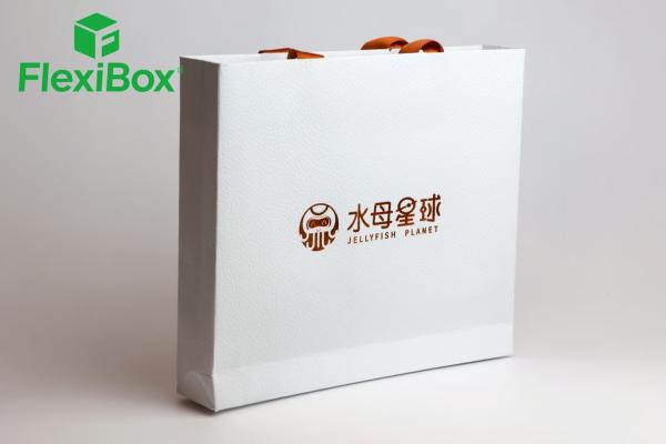 Quality Branded White Specialty Paper Tote Bag with Orange Flat-Cord Handles and Custom Graphic for sale